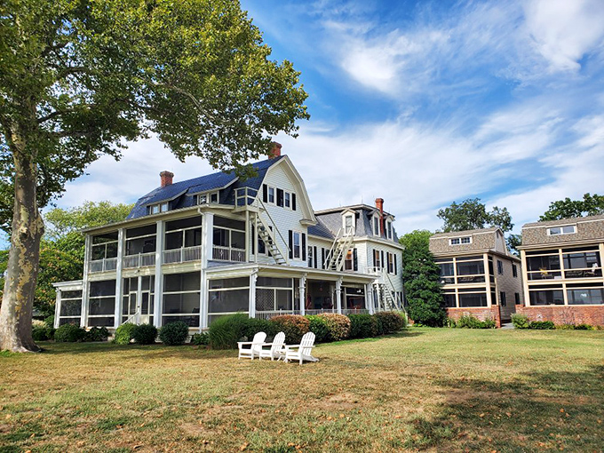 Sandaway Suites offers porch-perfect views where Adirondack chairs invite you to sit, sip, and seriously consider never returning to real life.