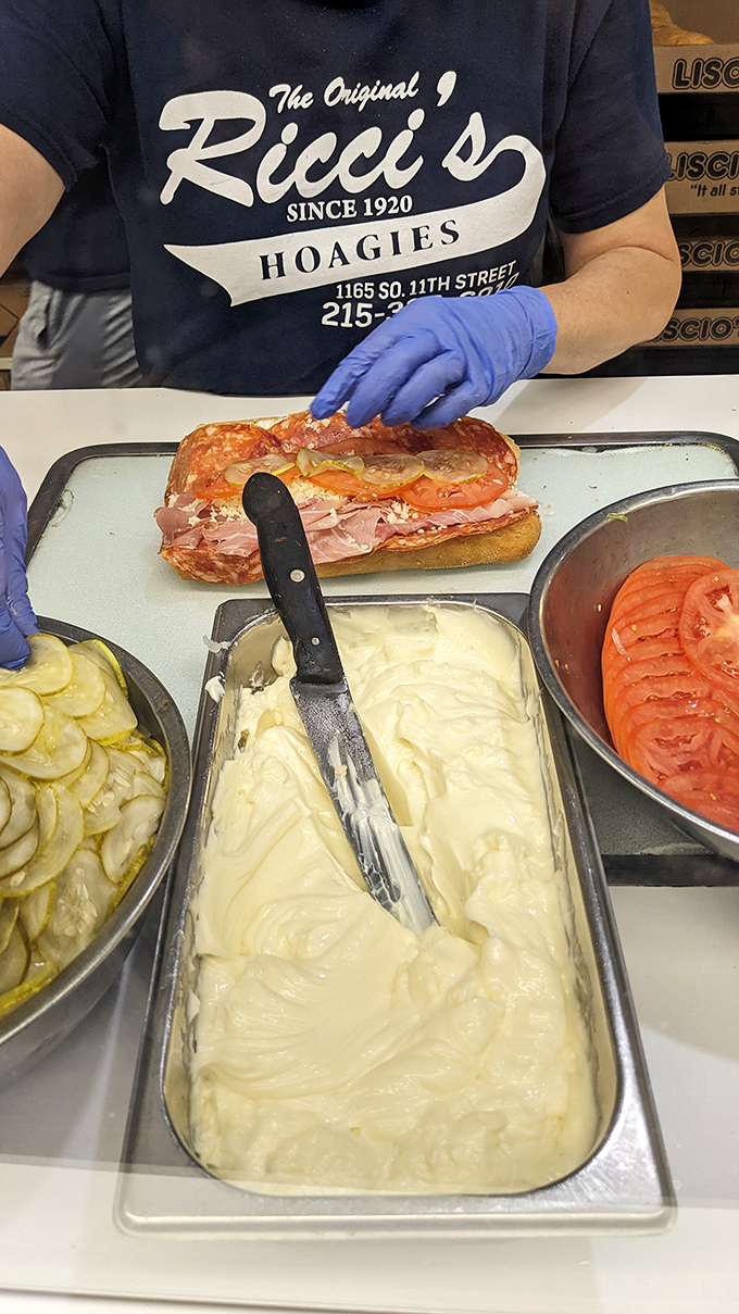 Sandwich assembly as performance art&mdash;fresh ingredients waiting their turn to join the carefully choreographed dance of hoagie construction.