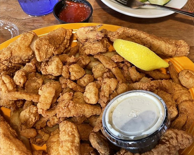 The seafood platter that dreams are made of. Golden-fried treasures from the deep with dipping sauce that makes you wonder if licking the plate is socially acceptable.