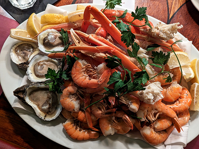 A seafood platter that would make Neptune himself jealous. Oysters, shrimp, and crab legs arranged like oceanic treasures on a pearl-white plate.