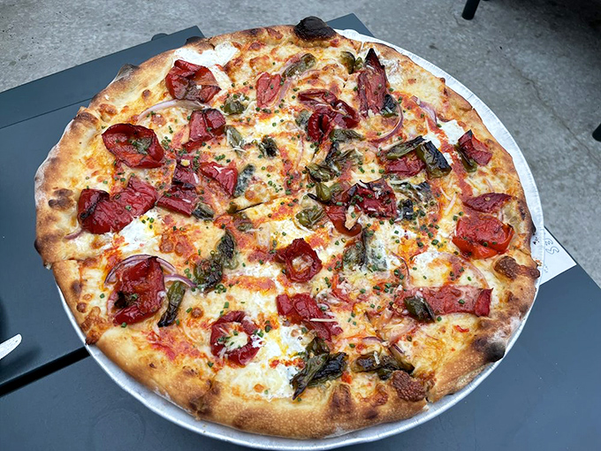 Sweet roasted peppers and what looks like sausage playing together on a canvas of perfect dough. A masterpiece in circular form.