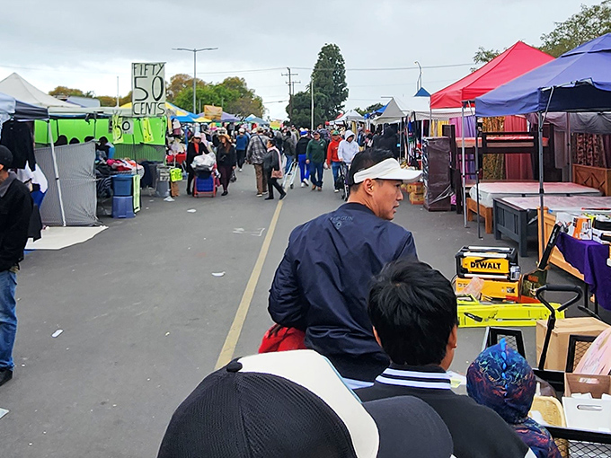 Bargain hunters in their natural habitat. The thrill of the hunt is written on every focused face.