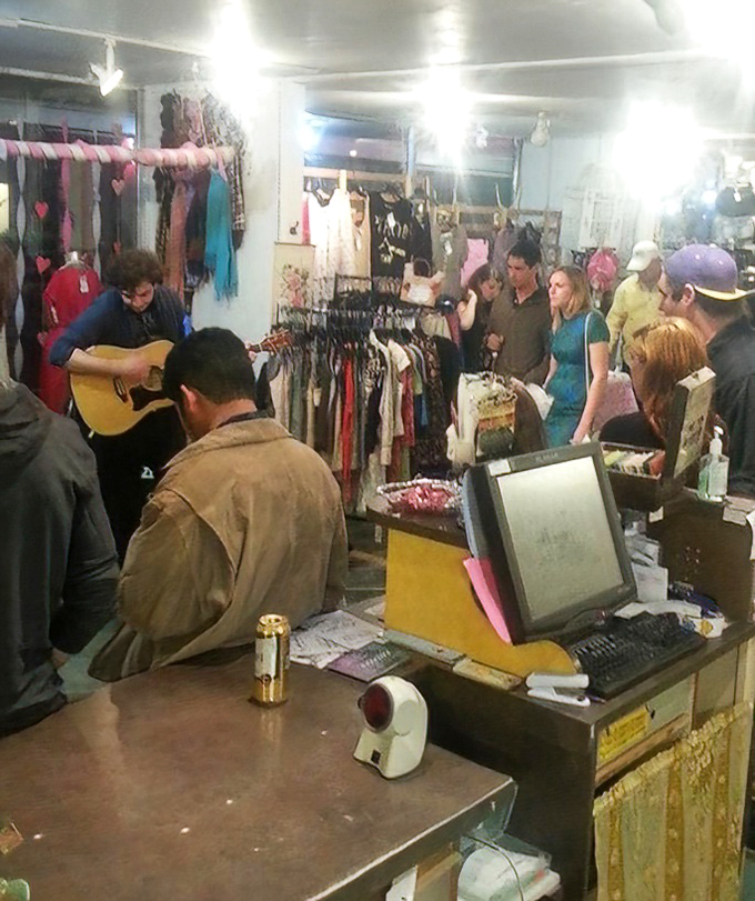 The thrill of the hunt in action&mdash;shoppers gathering for what appears to be an impromptu musical performance between bargain discoveries.