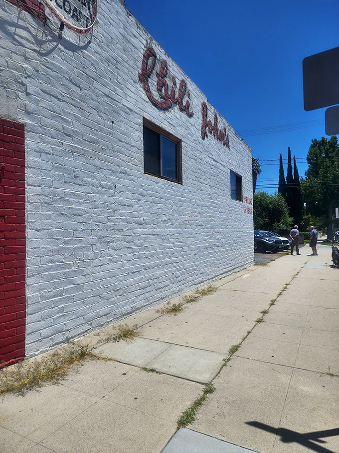 The simple white brick exterior with that classic red trim doesn't need to shout&mdash;it knows the chili inside speaks volumes.