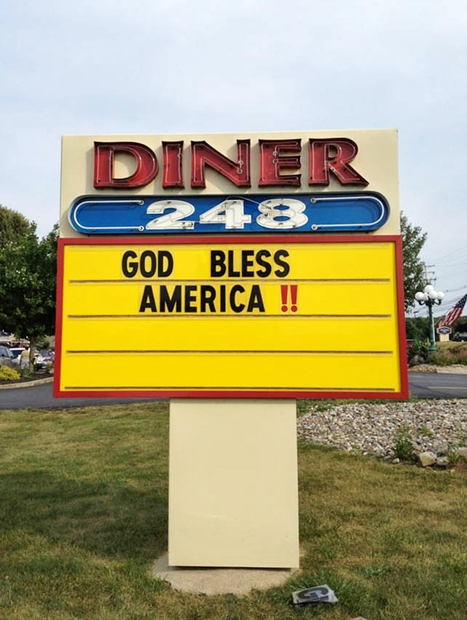 The roadside sign serves as both landmark and mood-setter, with a distinctly American optimism that matches the food inside.