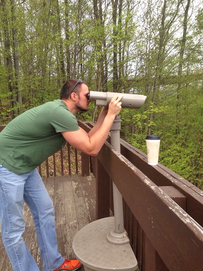 Searching for wilderness wonders. A visitor uses mounted binoculars to spot wildlife and take in panoramic views of the sprawling Kinzua gorge.