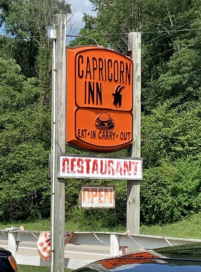 The iconic orange Capricorn Inn sign stands as a beacon of hope for hungry travelers&mdash;a roadside promise of honest food done right.