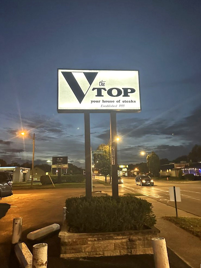 That vintage sign glows against the twilight sky, a beacon for hungry travelers and locals alike since 1955.