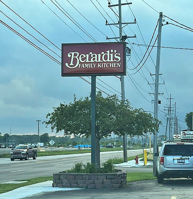 The roadside sign stands tall, a sentry guiding hungry travelers to breakfast bliss. No GPS needed when following your nose.