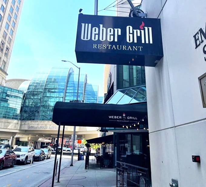 The street view promises urban sophistication, while that red kettle logo whispers, "Yes, we're serious about proper grilling techniques."