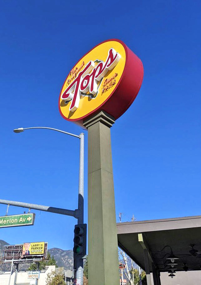 This towering sign stands proud against California's endless blue sky, a monument to breakfast done absolutely right.