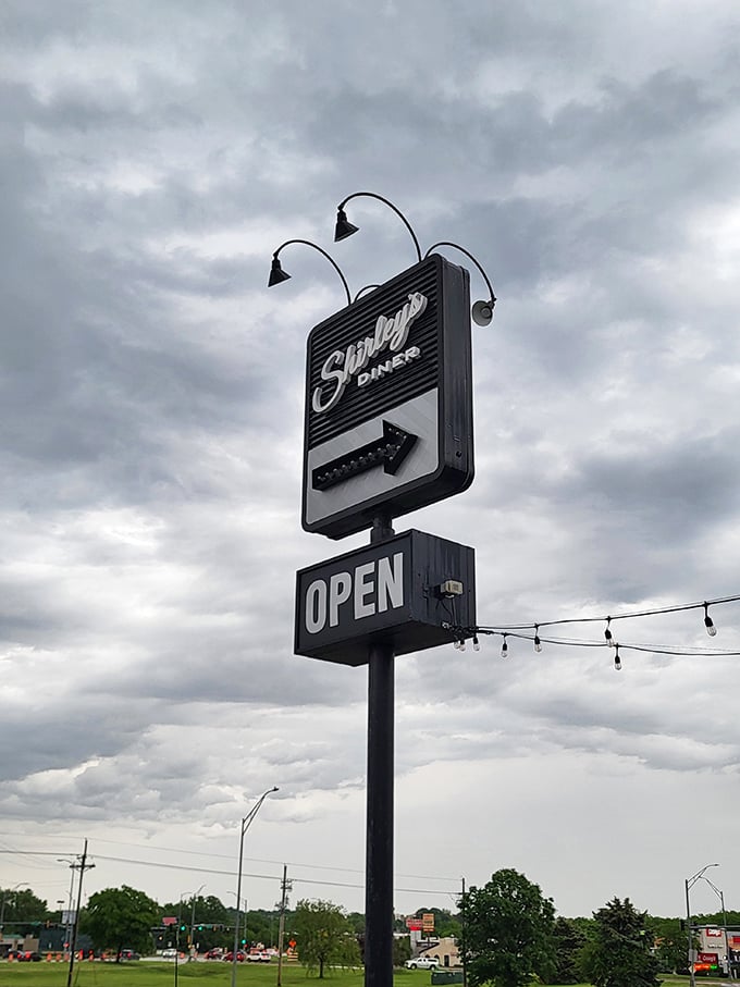 That sign stands tall like a lighthouse guiding hungry travelers to their happy place.