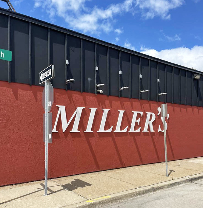 The bold red wall and white lettering announce "Miller's" with the quiet confidence of a place that doesn't need to shout about its greatness.