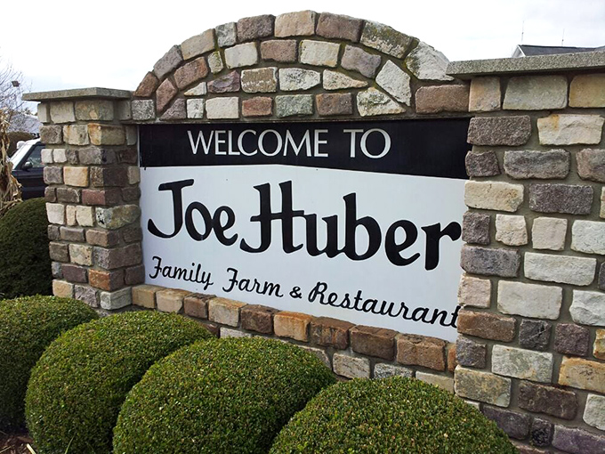 The stone entrance sign stands like a culinary Stonehenge, beckoning hungry travelers to the promised land of comfort food.