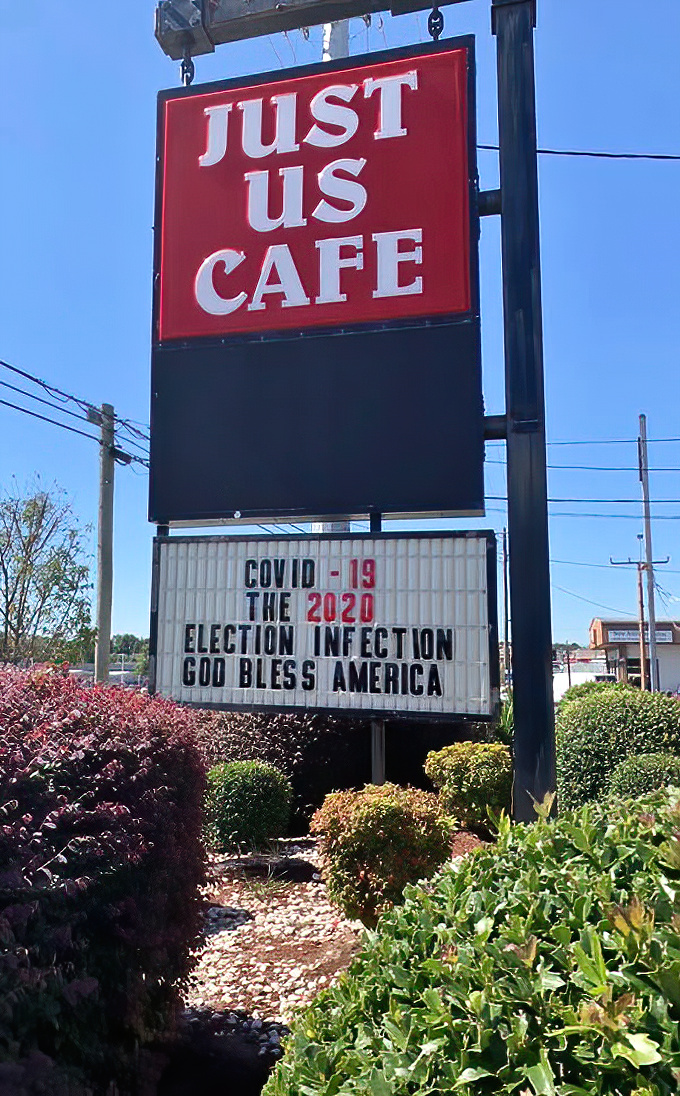 The sign promises "Just Us," but really means "All of Us"—a gathering place where community happens one breakfast at a time.