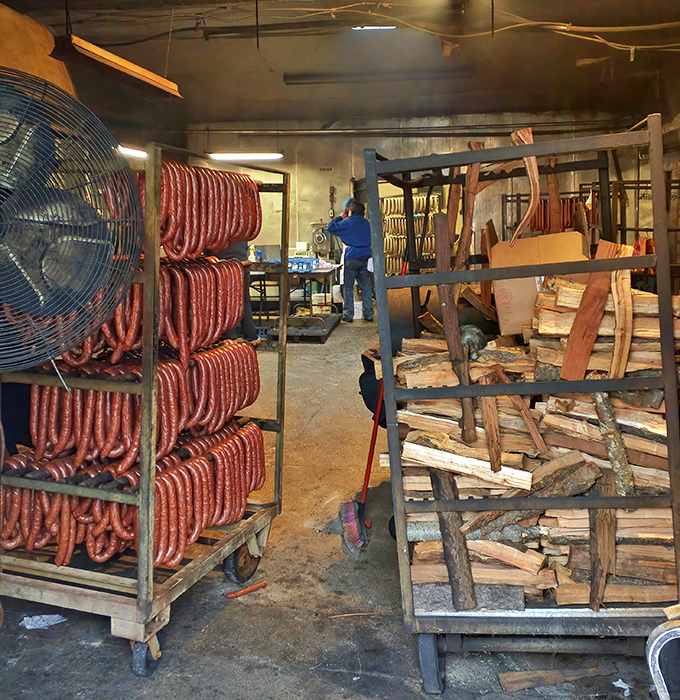 This isn't just a smokehouse; it's a temple where wood stacks and meat racks come together in a delicious communion. 