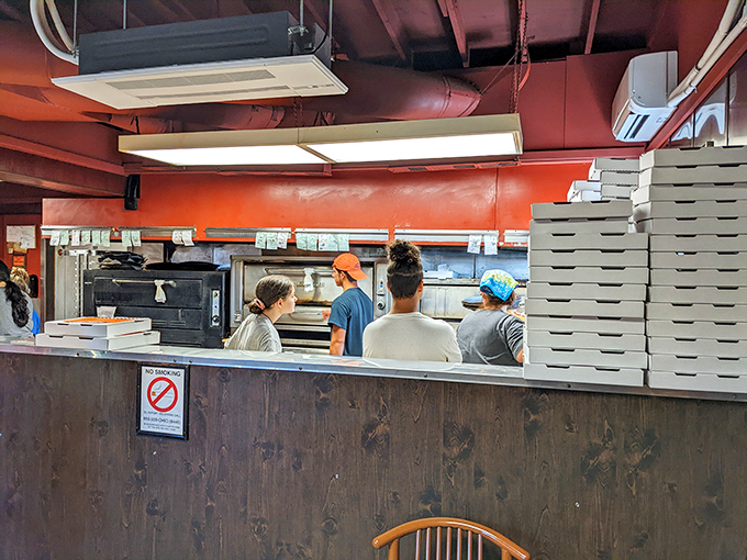 Hardworking kitchen staff crafting each order with care &ndash; the real heroes behind every perfect pizza slice.