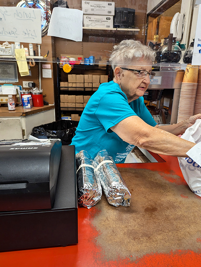 Behind the counter, experienced hands work their magic, transforming simple ingredients into legendary Philadelphia sandwiches.