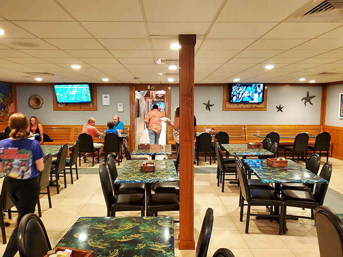 The dining room where seafood dreams come true. Those underwater-themed tabletops remind you exactly where your dinner originated before its journey to your plate.