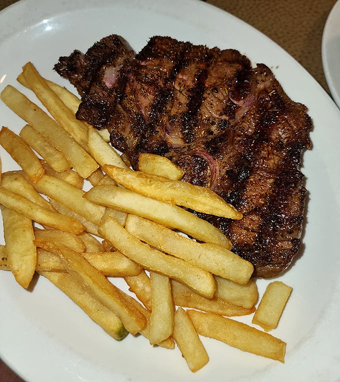A steak with the perfect sear marks that say "our grill master showed up today." Those golden fries aren't an afterthought &ndash; they're essential supporting actors.