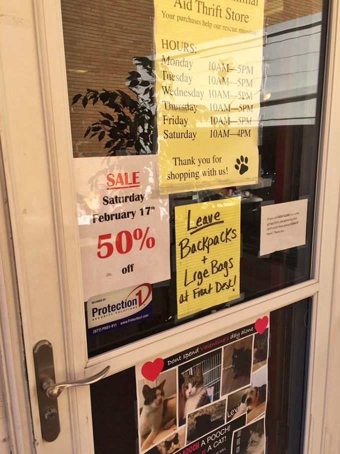 The store hours sign that reminds you this isn't just shopping&mdash;it's a mission. Those paw prints aren't just cute; they're the reason you're here.