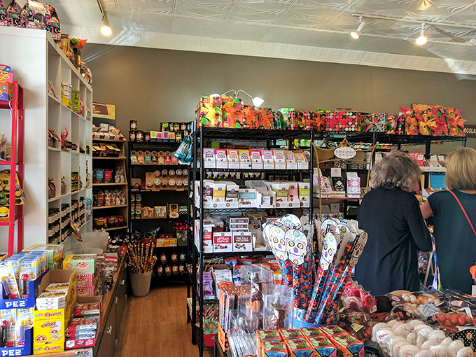 Customers browse with the focused concentration of archaeologists, hunting for extinct childhood treats among modern confectionery treasures.