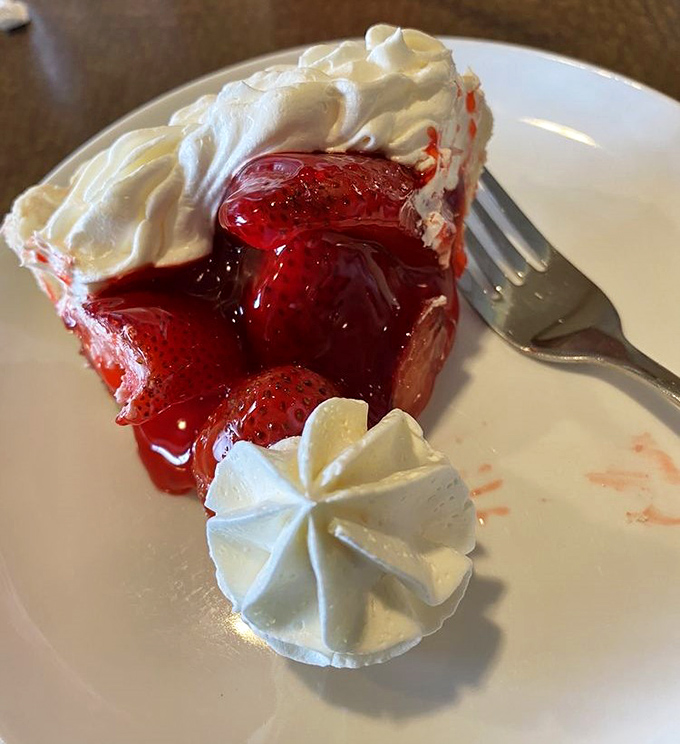 The famous strawberry pie makes its grand entrance&mdash;ruby red filling crowned with clouds of whipped cream. Dessert royalty that's earned every bit of its reputation.