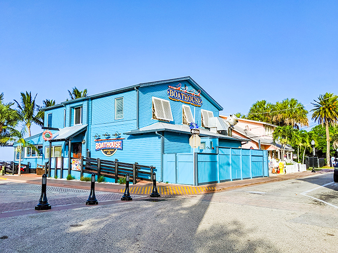 The vibrant turquoise Boathouse Restaurant stands like a beacon of coastal dining, where seafood tastes better with waterfront views.