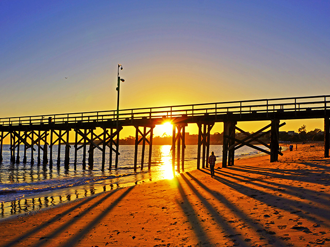 As the sun dips through Goleta's pier, it transforms ordinary wood into a golden gateway, proving nature remains California's most talented lighting designer.