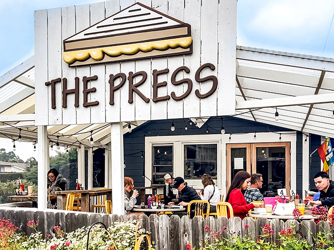 The Press isn't just serving coffee; it's hosting the daily gathering of locals who know that caffeine tastes better with coastal air.