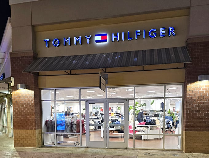 Tommy Hilfiger's iconic Americana glows invitingly after dark. Classic preppy styles await inside, promising to upgrade your wardrobe without downgrading your savings.