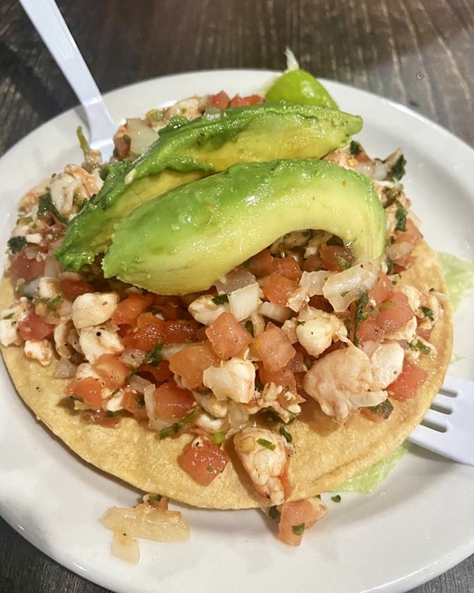 Ceviche tostada topped with nature's butter. When seafood meets lime and avocado, it's a coastal vacation on a corn canvas.