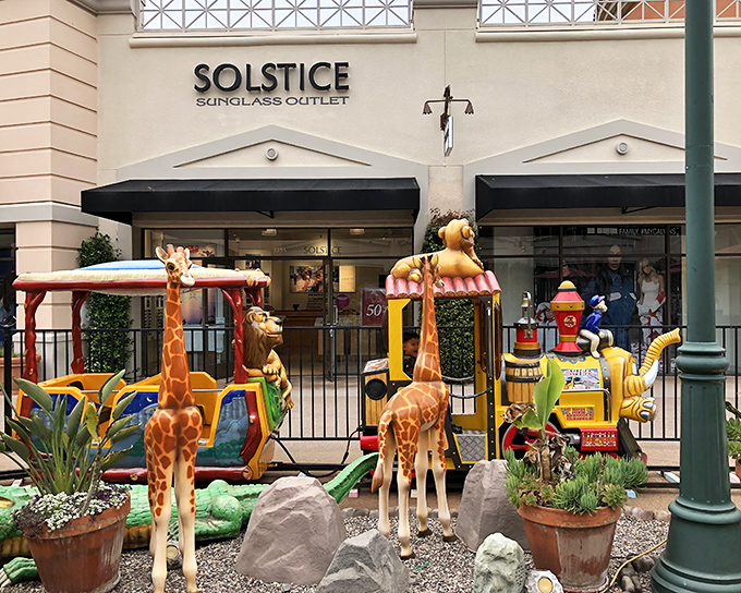 Whimsical giraffe rides provide the perfect distraction for tiny shoppers while parents debate whether those sunglasses are actually a good deal.