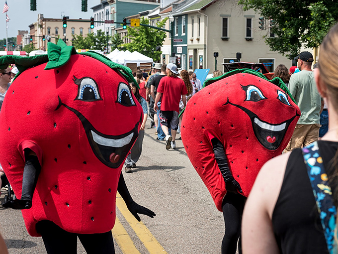 The Strawberry Festival mascots bring berry big smiles to downtown Troy during the annual celebration that puts the "fun" in funky fruit costumes.