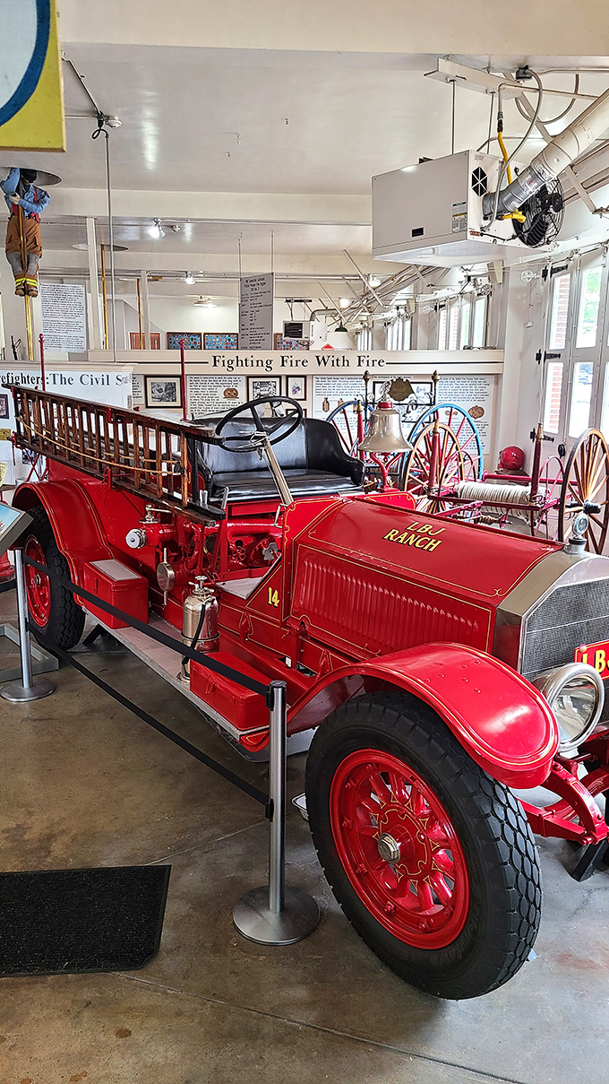 Classic red fire engine gleaming like a ruby, ready to rescue anyone from a boring museum visit.