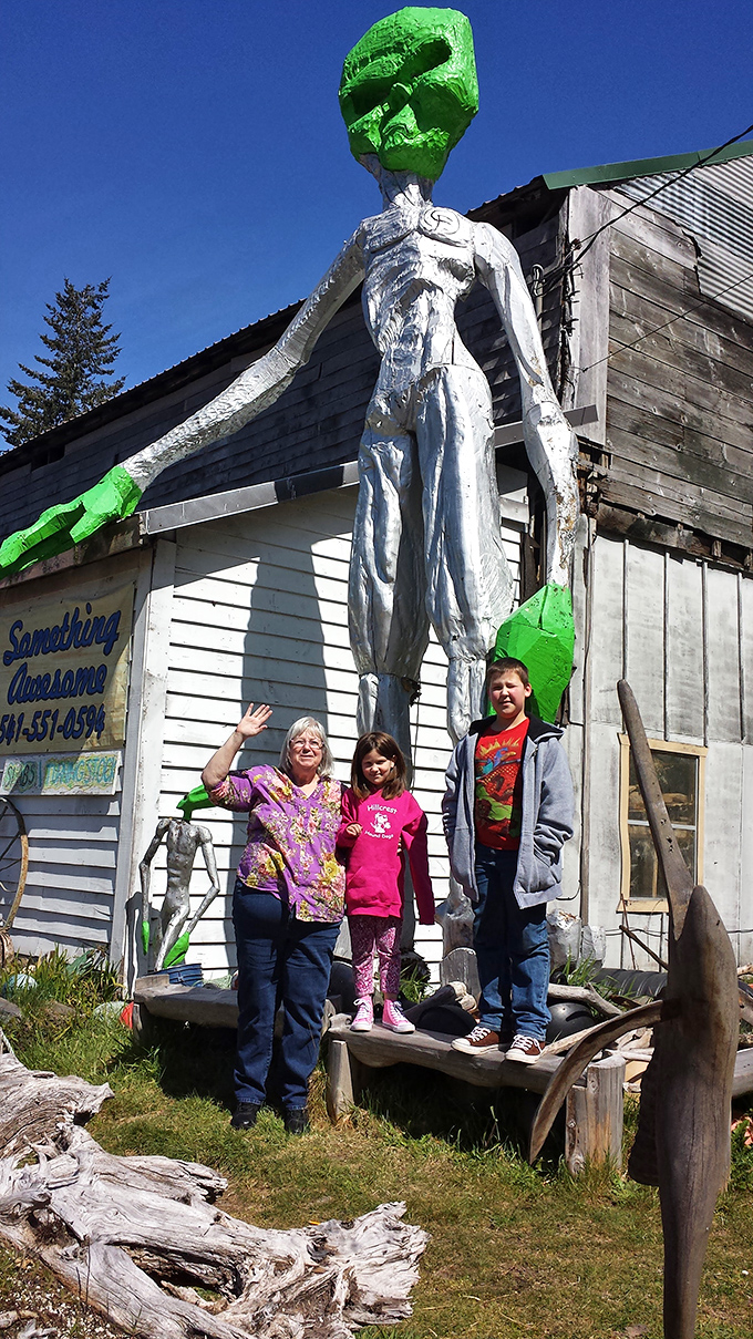 Visitors pose with the towering alien sculpture, creating memories that are, quite literally, out of this world.