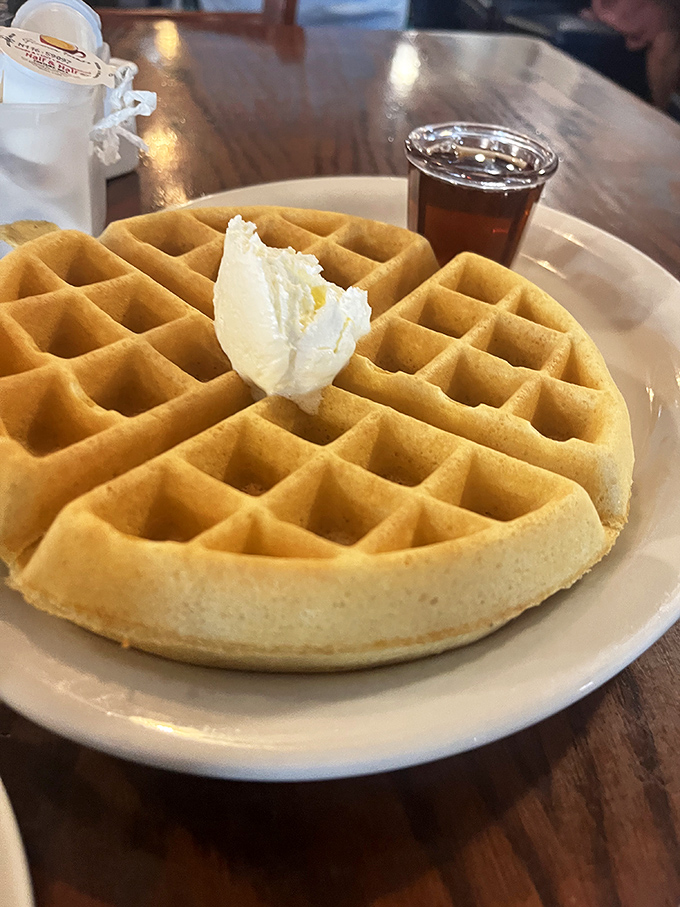 This isn't just any waffle&mdash;it's the perfect balance of crisp exterior and fluffy interior, with butter melting into each square like it was designed by breakfast engineers.