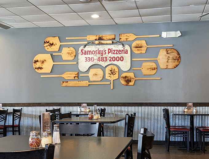Pizza paddles transformed into wall art&mdash;a creative reminder that you're in the hands of people who take their pizza craft seriously.