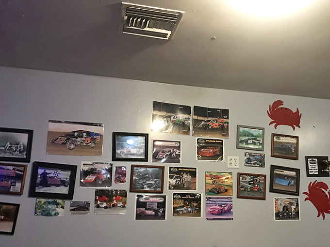 The wall of racing photos and memorabilia reveals the unexpected personality quirks that make small restaurants so endearing.