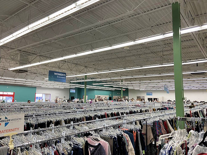 The women's clothing section stretches as far as the eye can see, with racks organized by type and size for efficient treasure hunting.