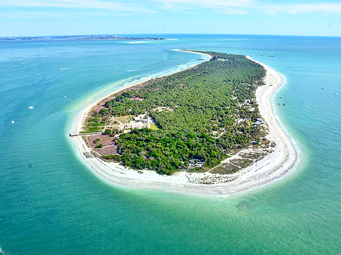 The island reveals its true form from above—a comma-shaped paradise surrounded by waters so blue they look Photoshopped, even when they're not.