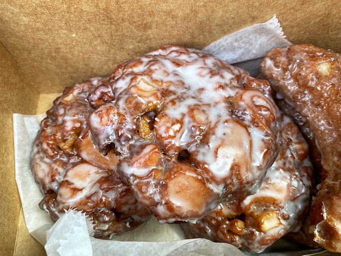 Apple fritters with a glaze so perfect it looks like it was applied by Renaissance artists &ndash; sweet, sticky evidence that simplicity done right is culinary genius.