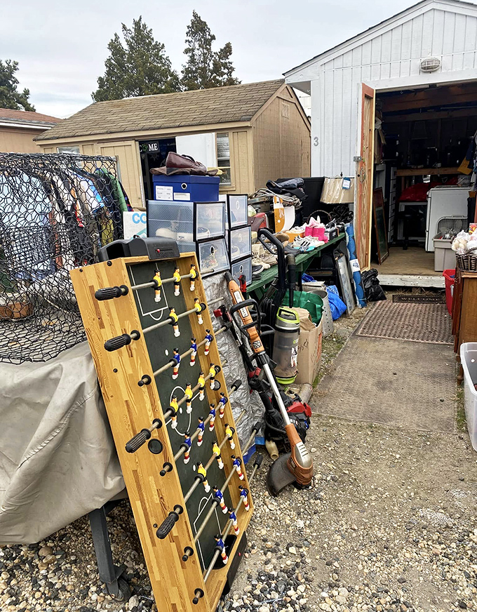 Game night, anyone? This foosball table leans casually against outdoor inventory, waiting for its next family championship match in someone's basement.