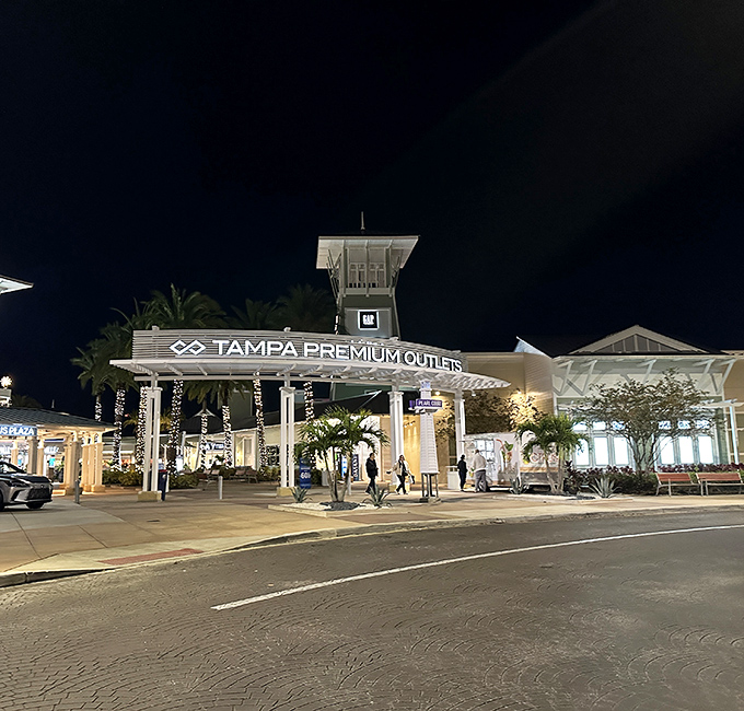 The illuminated entrance welcomes night owls and evening shoppers with a glow that promises "good deals inside."
