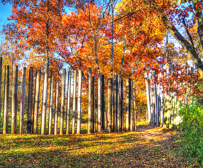 Fall foliage creates a fiery backdrop for the wooden palisade&mdash;Mother Nature's special effects department working overtime to impress visitors.