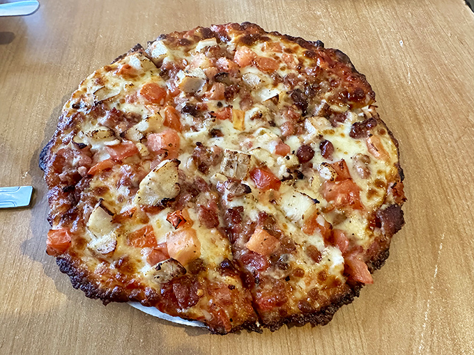 This isn't just any pizza&mdash;it's a flavor collaboration where bacon and chicken find their perfect partners in a creamy Alfredo backdrop.