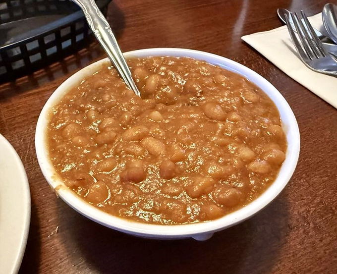 Baked beans that have clearly been simmering since breakfast, absorbing all the wisdom the kitchen has to offer.