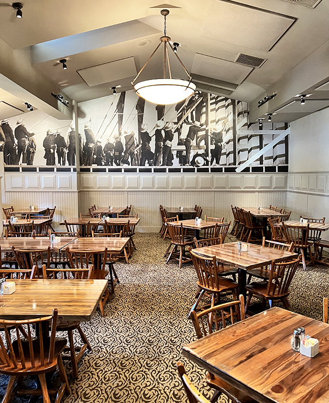 The dining room's historical mural watches over wooden tables like a guardian of good taste. Generations have created memories in this very space.