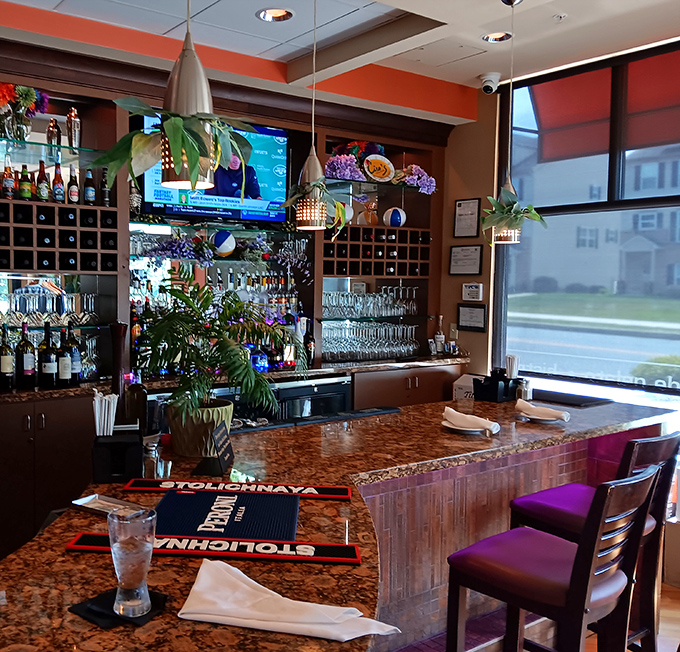 The well-stocked bar area suggests serious attention to both food and beverage pairings.