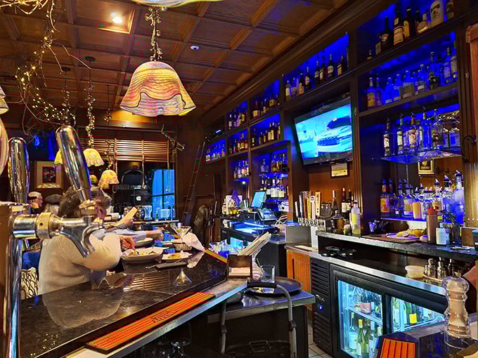 A bar that takes its liquid artistry seriously. That blue backlit display isn't just pretty&mdash;it's showcasing an impressive arsenal of spirits ready for action.